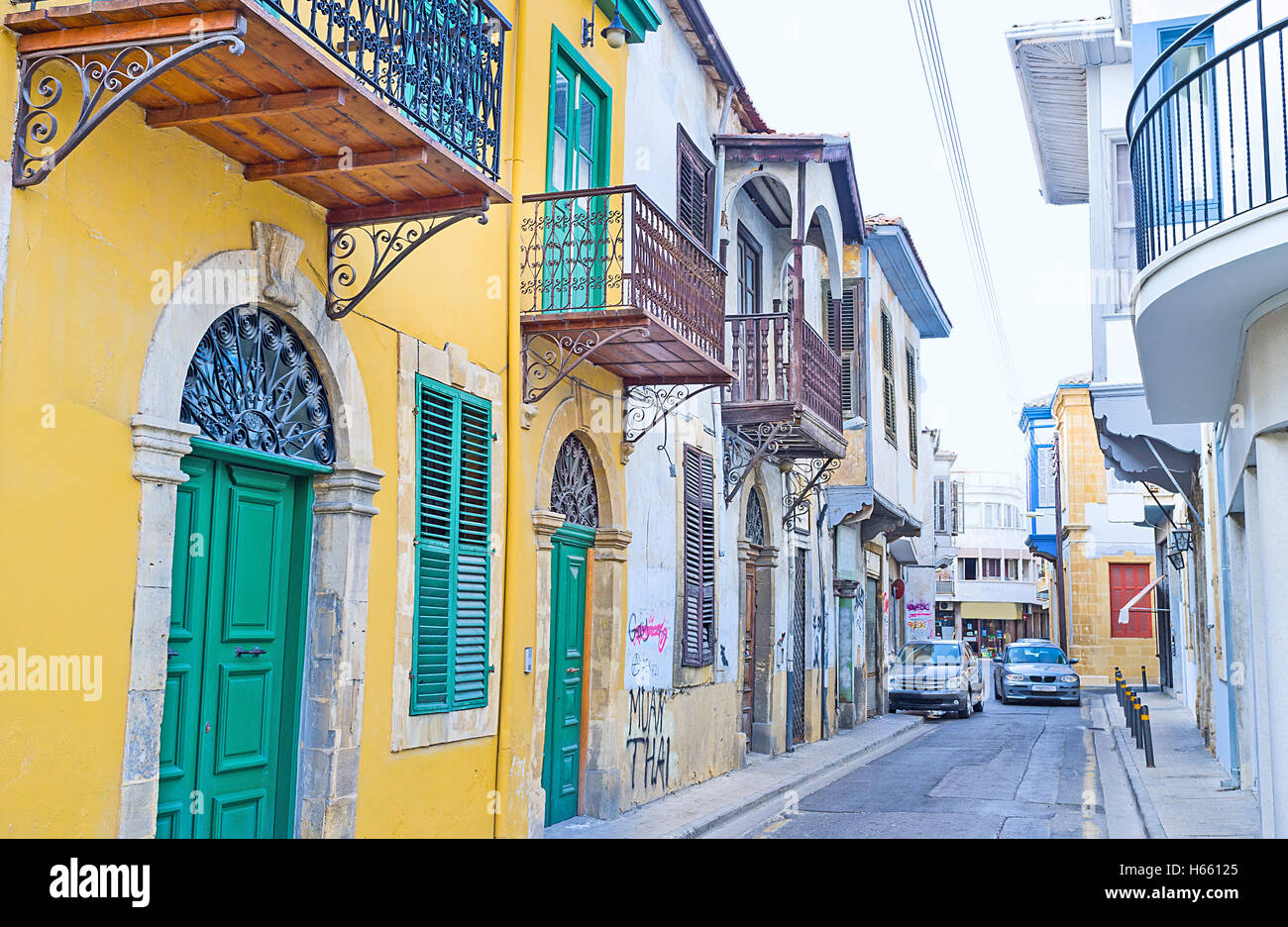 The quiet street in the old town with colorful houses and tiny stalls ...