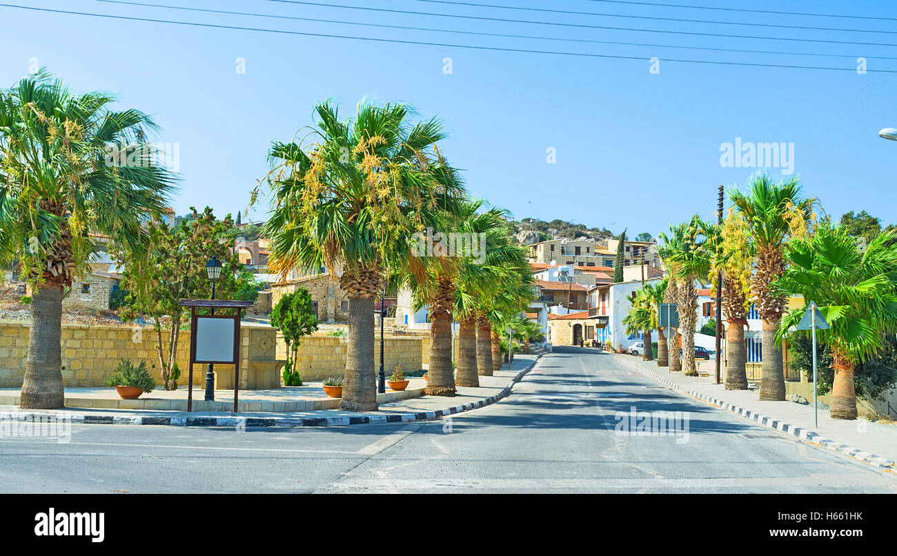 The street with green palms leads to the old village centre ...
