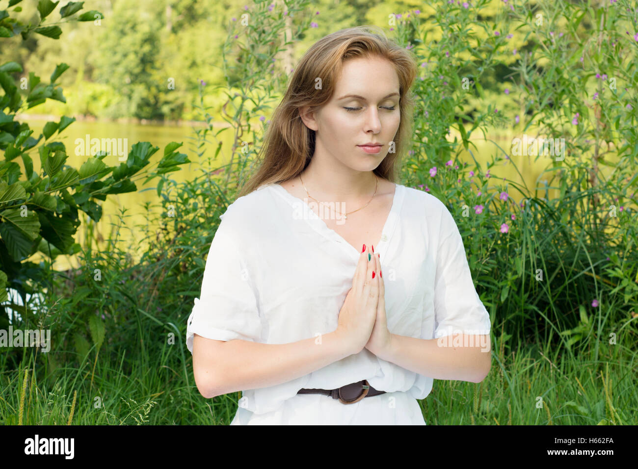 Young female meditating in hi-res stock photography and images - Alamy