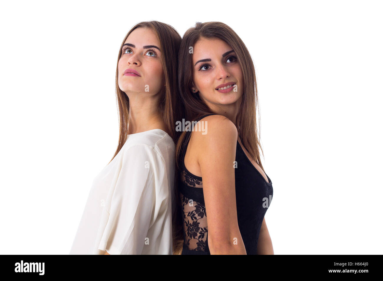 Two women standing back to back hi-res stock photography and images - Alamy
