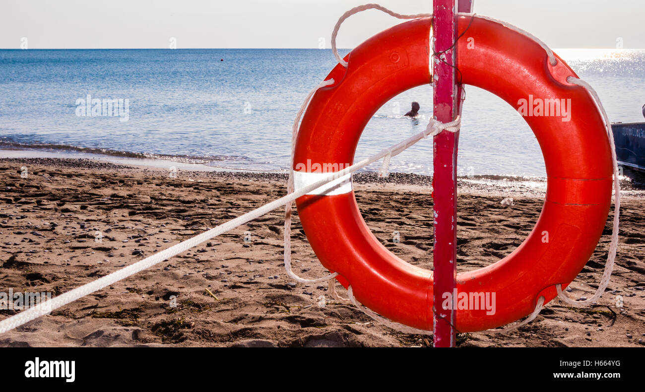 Red lifebelt on the beach. Ionian Sea, Calabria. Italy Stock Photo - Alamy