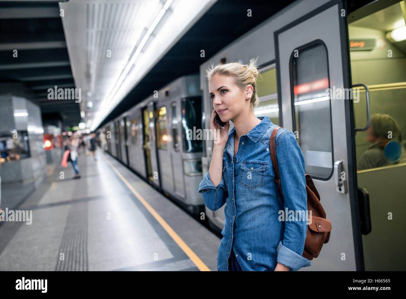 Woman making phone call at the underground platform Stock Photo - Alamy