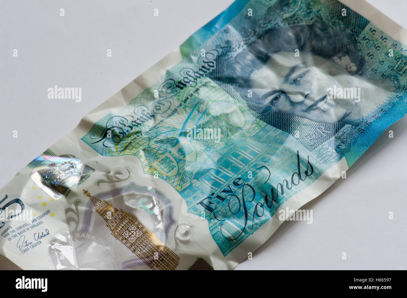 Crumpled up new five pound note Stock Photo - Alamy