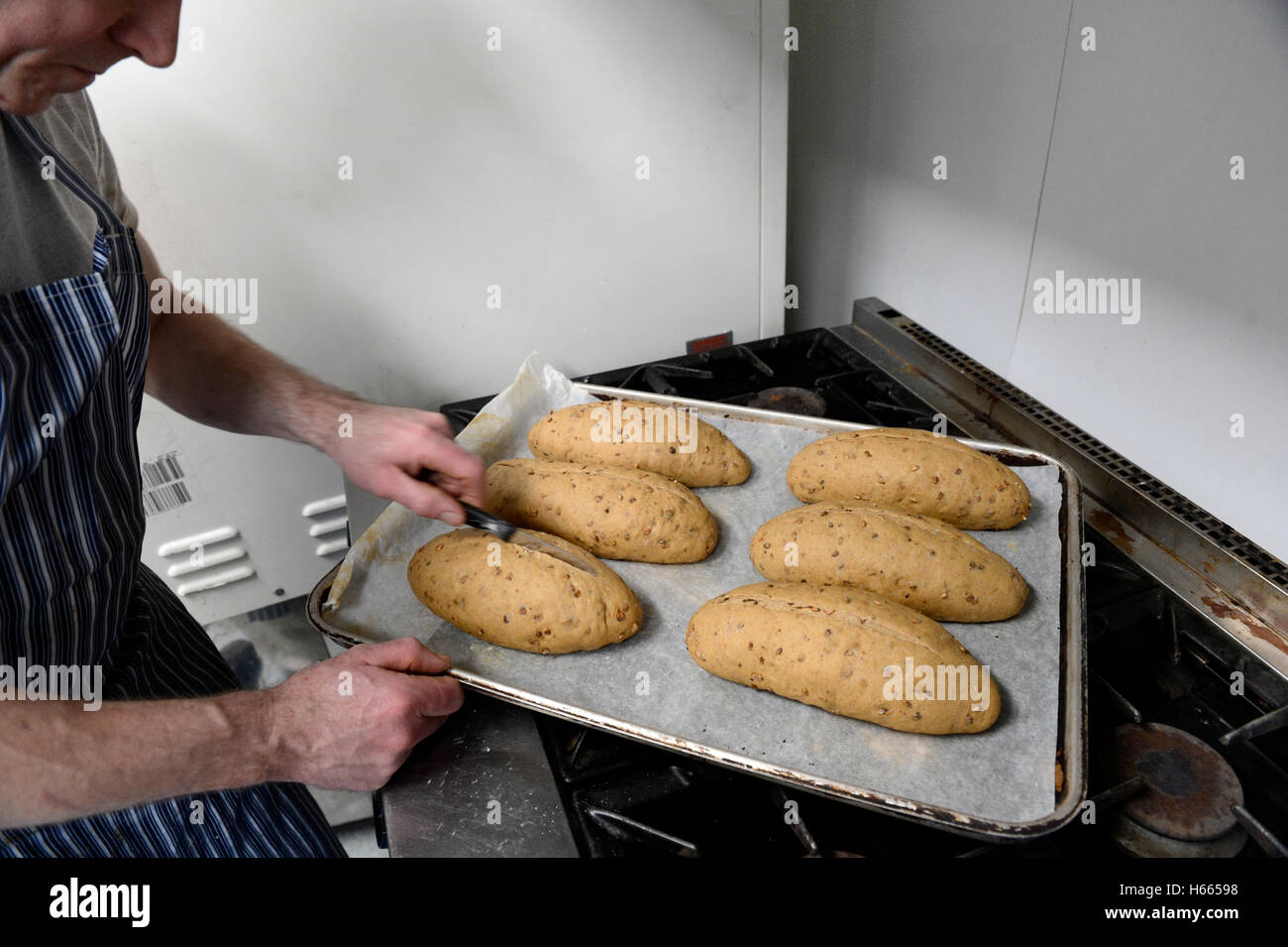 Baker making recipes and baking cakes and loaves in an oven Stock Photo ...