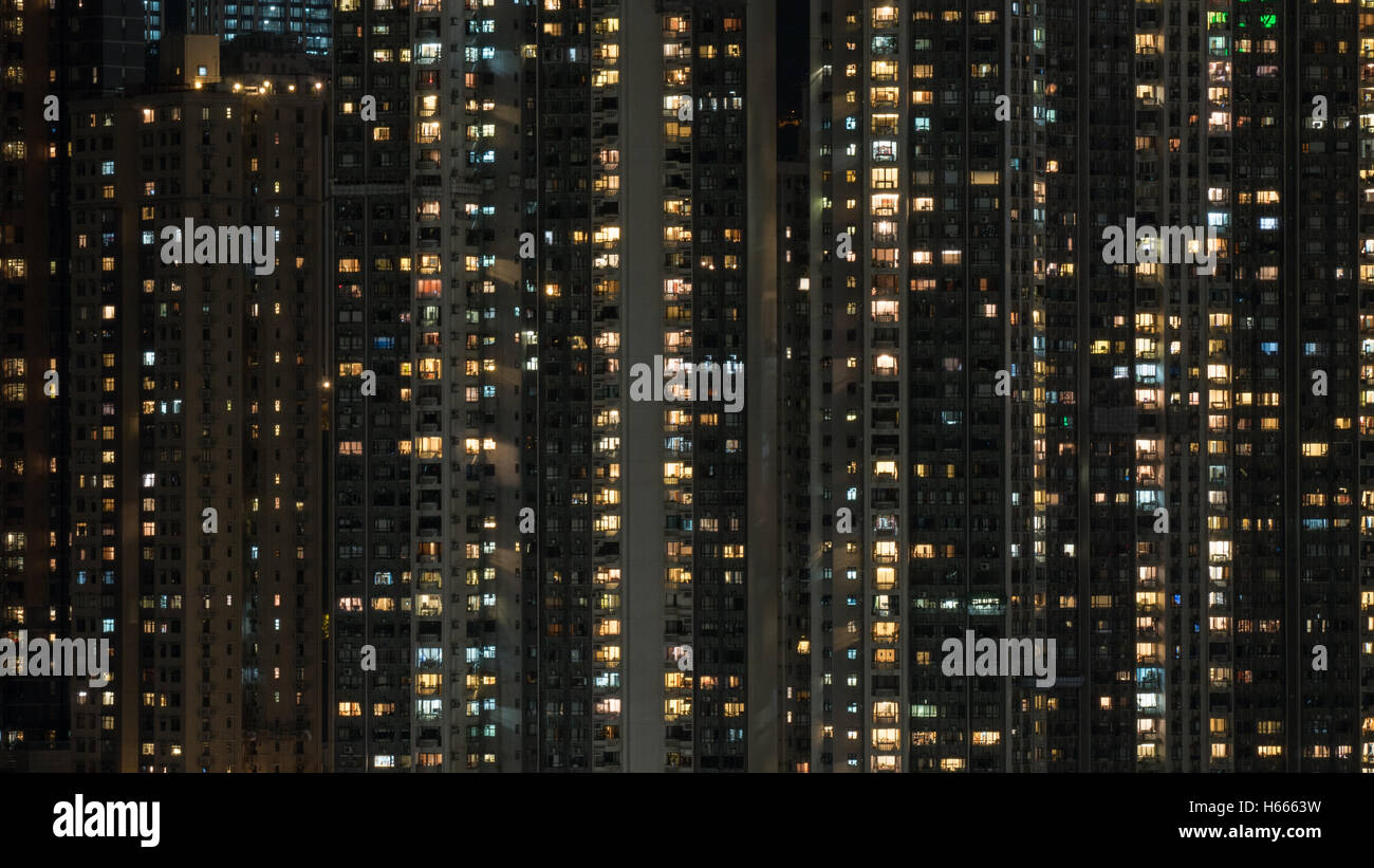 Window lights in high-rise apartment block at night Stock Photo - Alamy