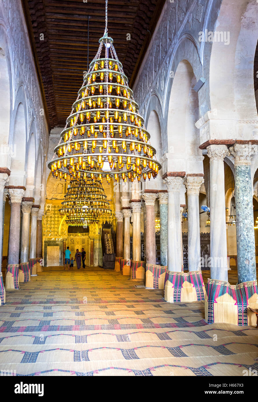 The interior of the Great Mosque with the large chandeliers, many ...