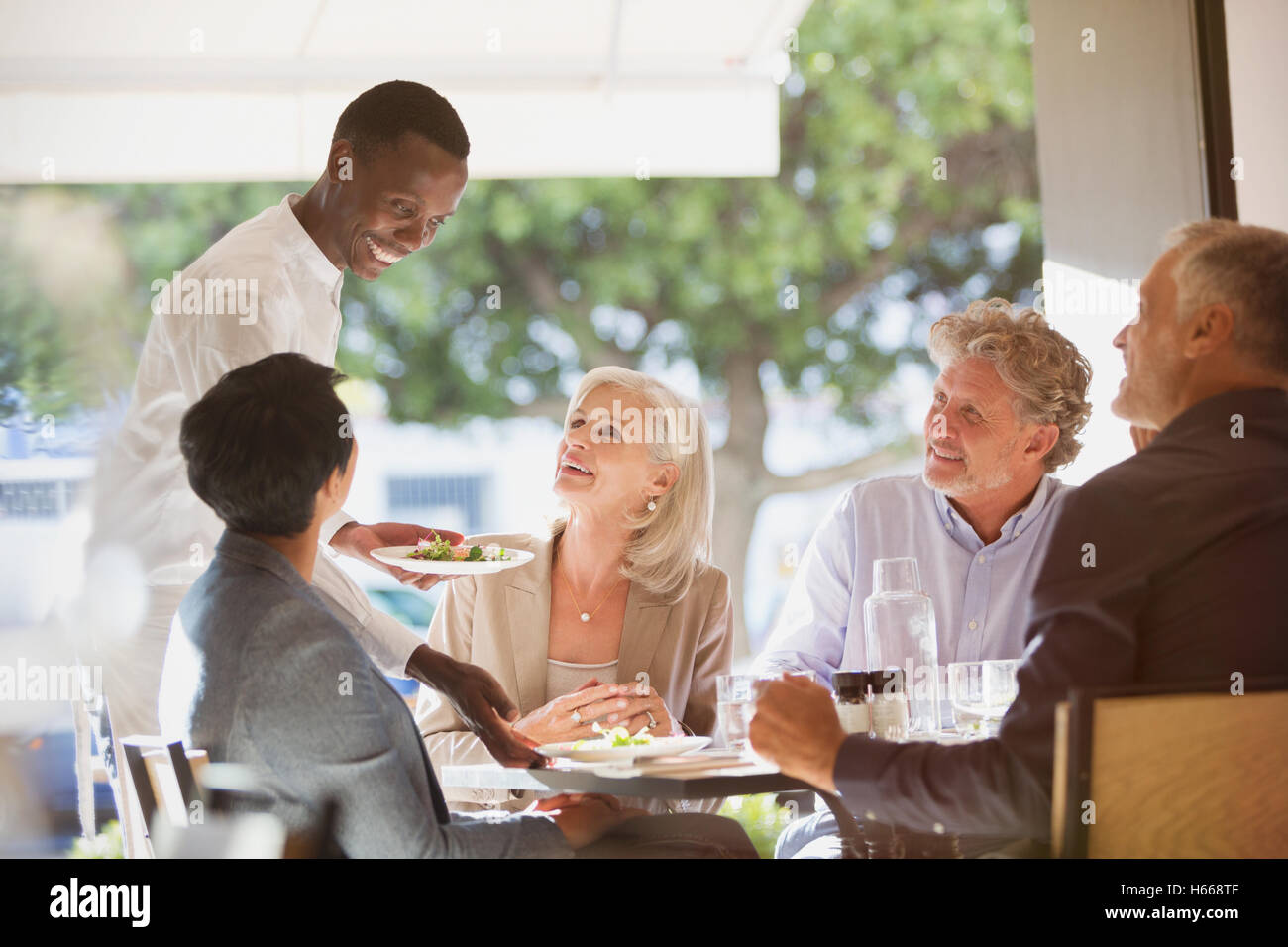 Waiter serving food restaurant hi-res stock photography and images - Alamy