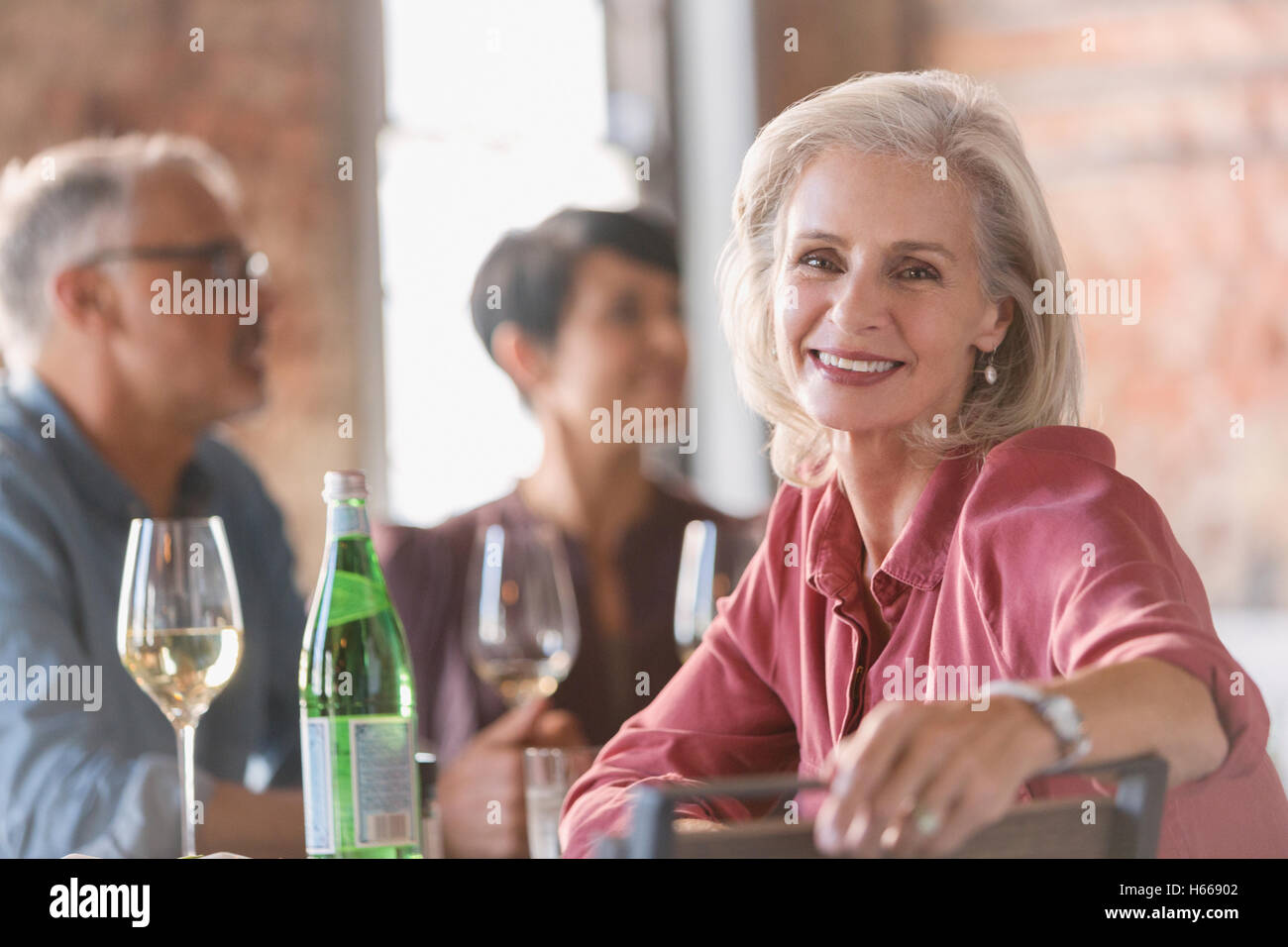 Portrait smiling senior woman dining with friends in restaurant Stock ...
