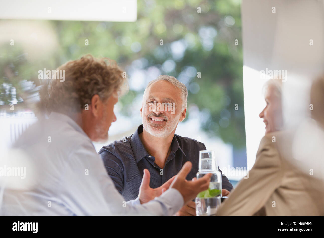 Friends talking and dining in restaurant Stock Photo - Alamy
