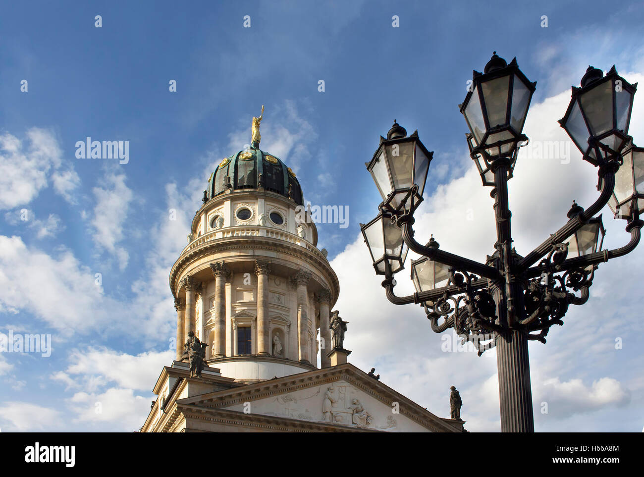 Historical, old street lamp with French cathedral and cloudy blue sky ...