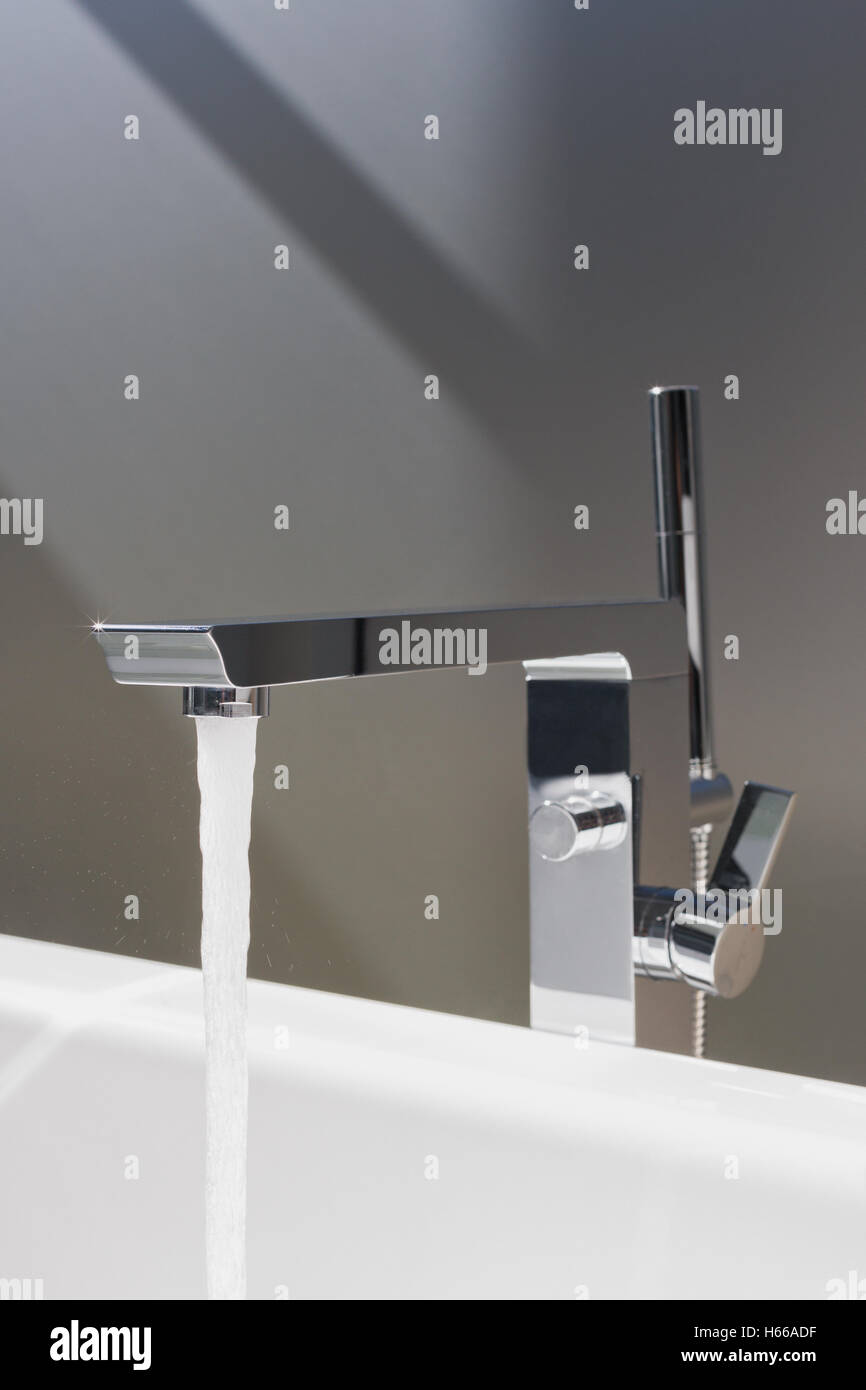 Close up water falling from modern bathroom faucet Stock Photo - Alamy