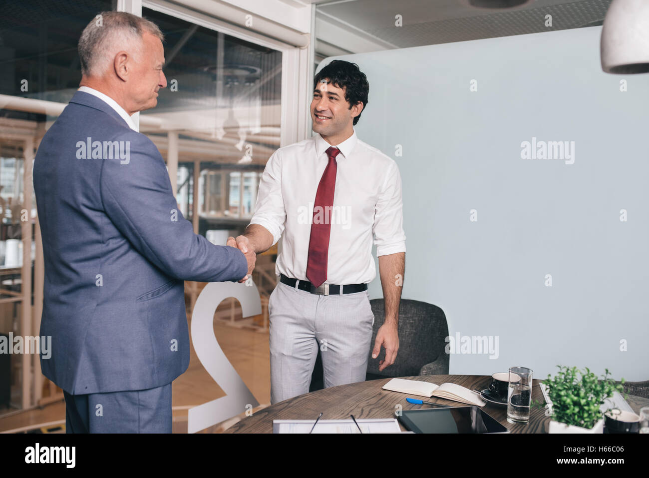 Handshake two young businessmen hi-res stock photography and images - Alamy