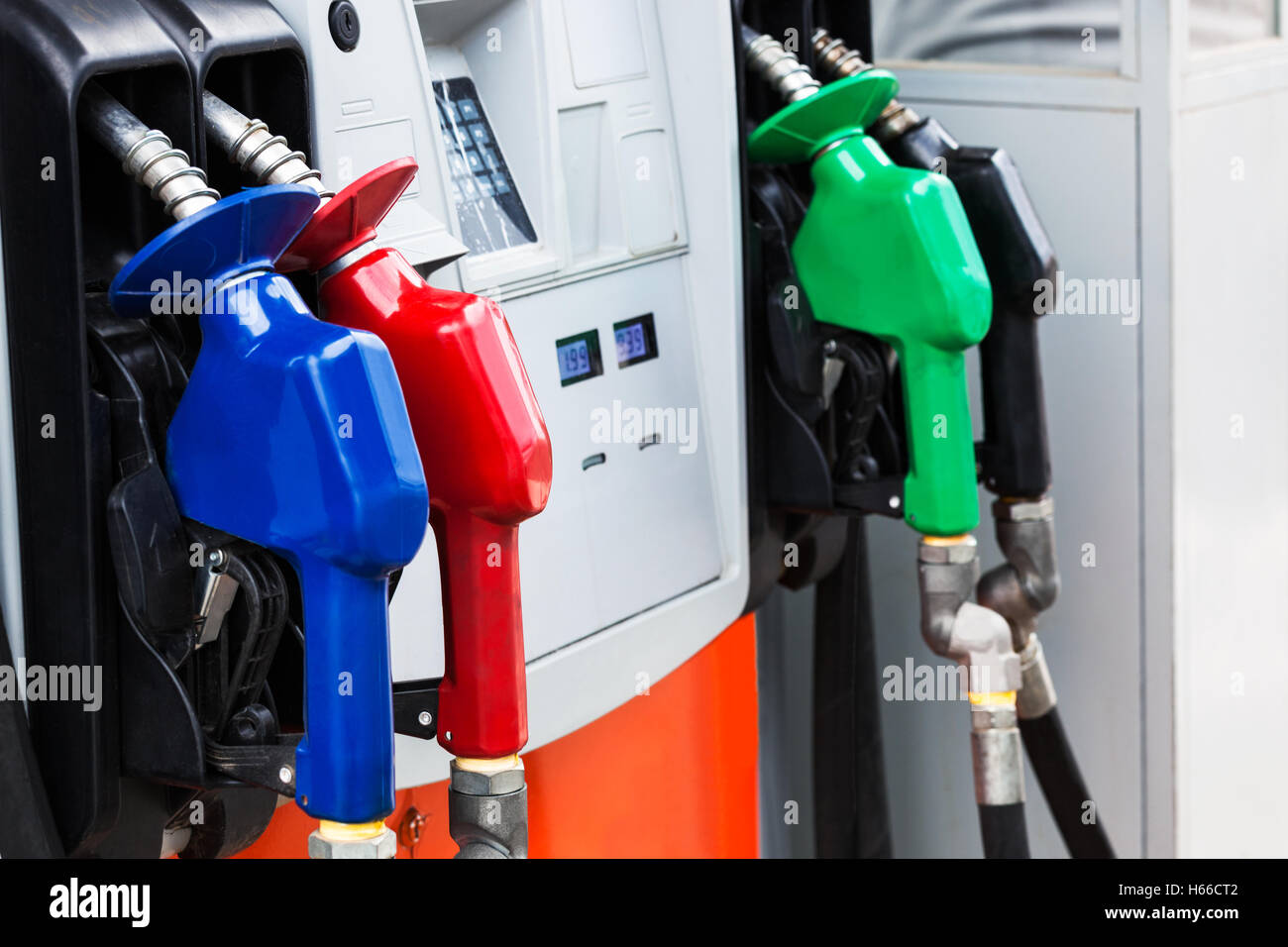 four gas hoses on a modern gas station Stock Photo - Alamy