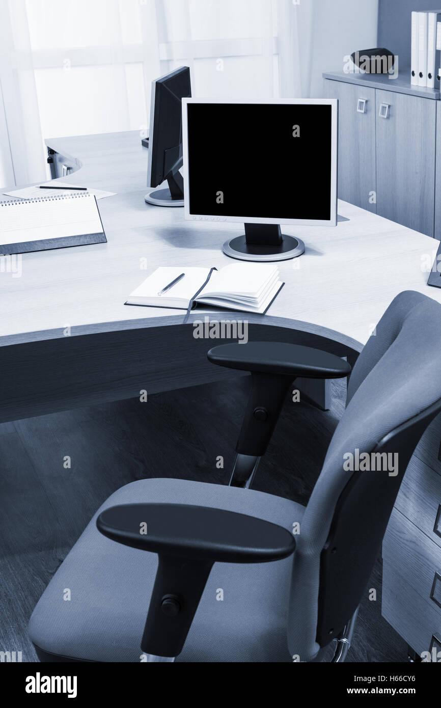 computer monitors on a desk in a modern office Stock Photo - Alamy