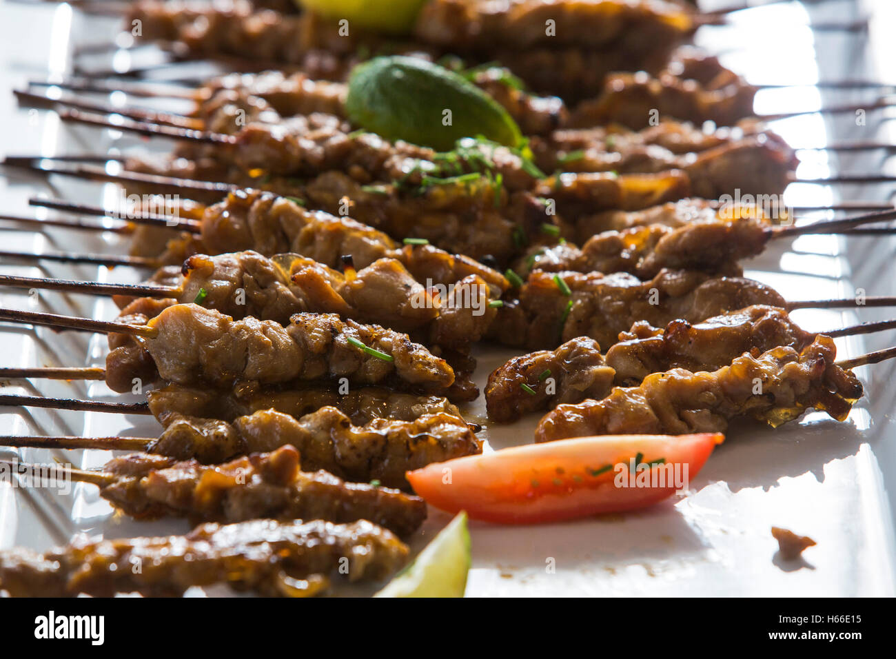 Platter of chicken satay on wooden skewers set out in a buffet Stock ...