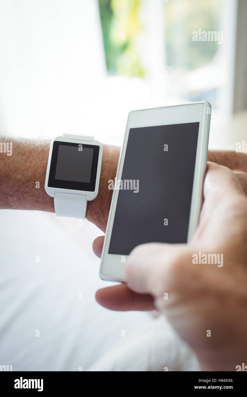 Using smartwatch phone elderly man hi-res stock photography and images ...