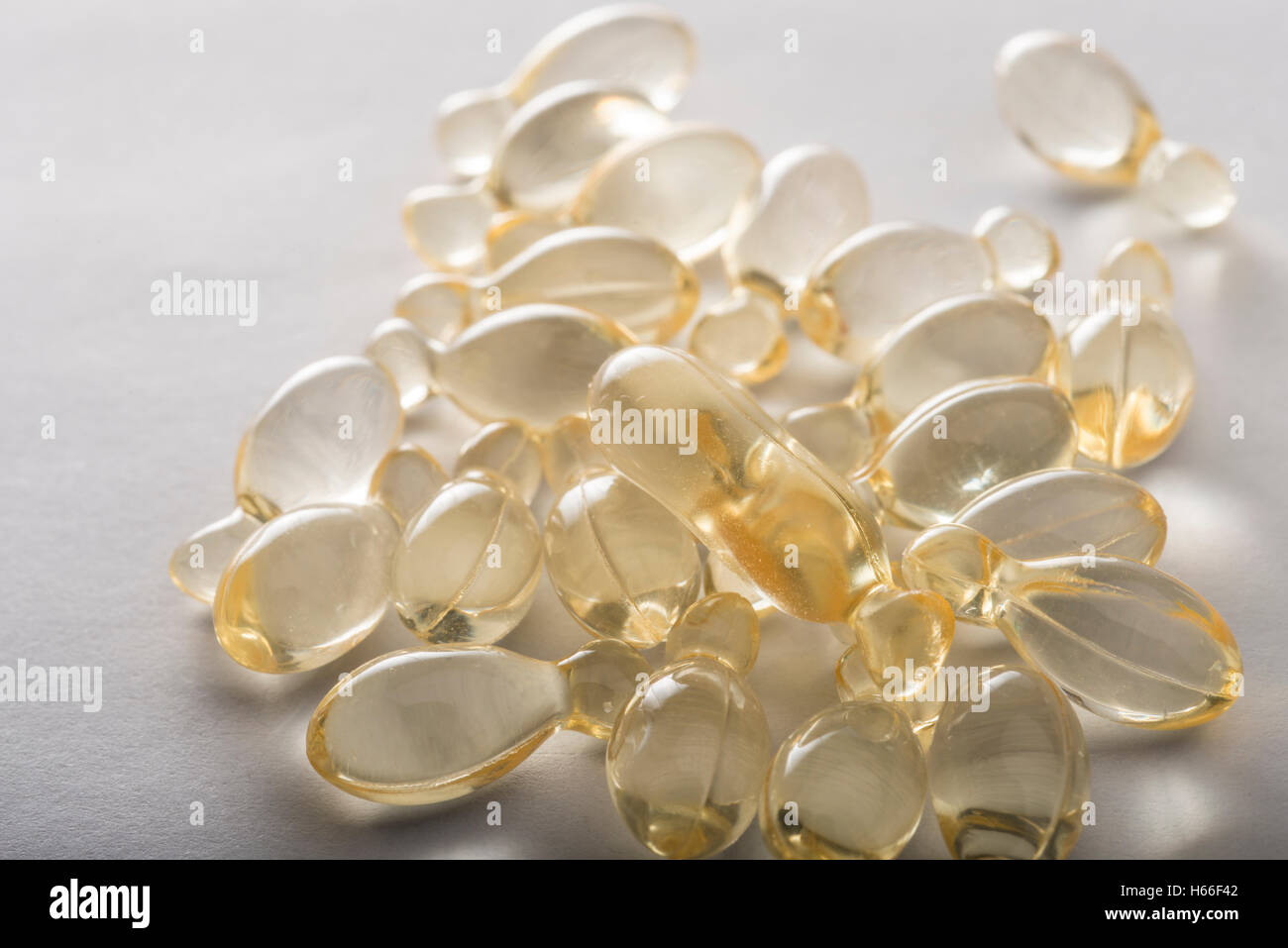 Gel capsules on the white background Stock Photo - Alamy