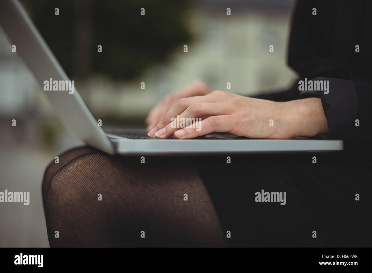 Mid section of businesswoman using laptop Stock Photo - Alamy