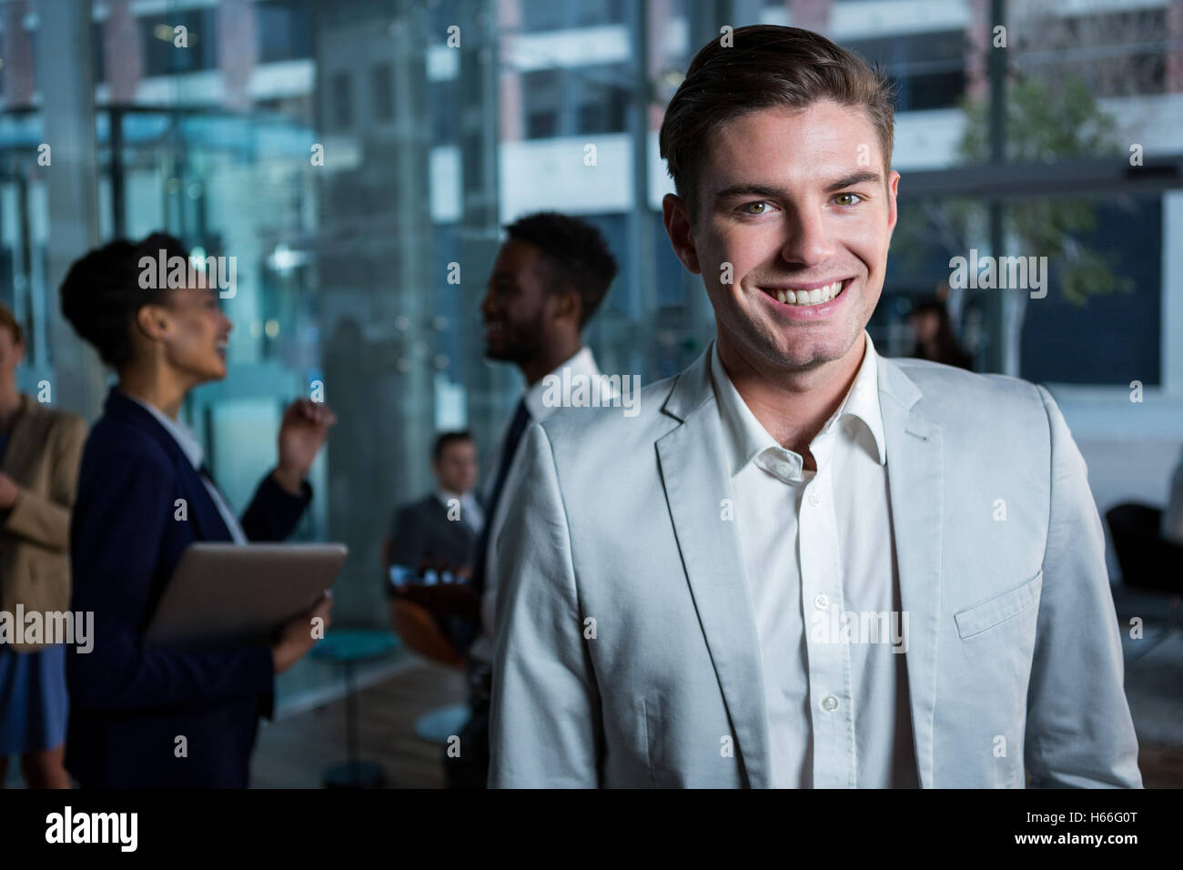 Portrait of smiling businessman Stock Photo - Alamy