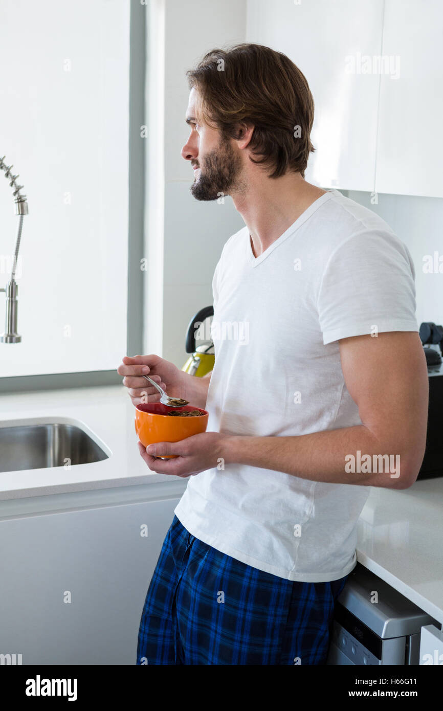 Man having breakfast in kitchen Stock Photo - Alamy