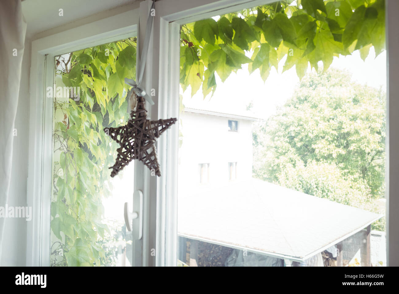 Wicker star hanging on a window Stock Photo - Alamy