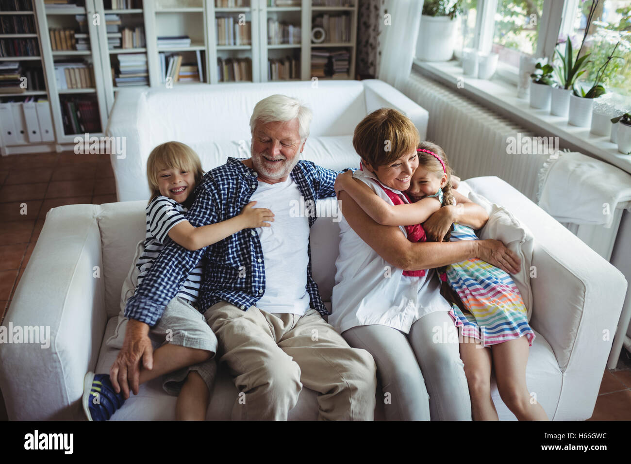 Grandparents having fun with their grandchildren Stock Photo - Alamy