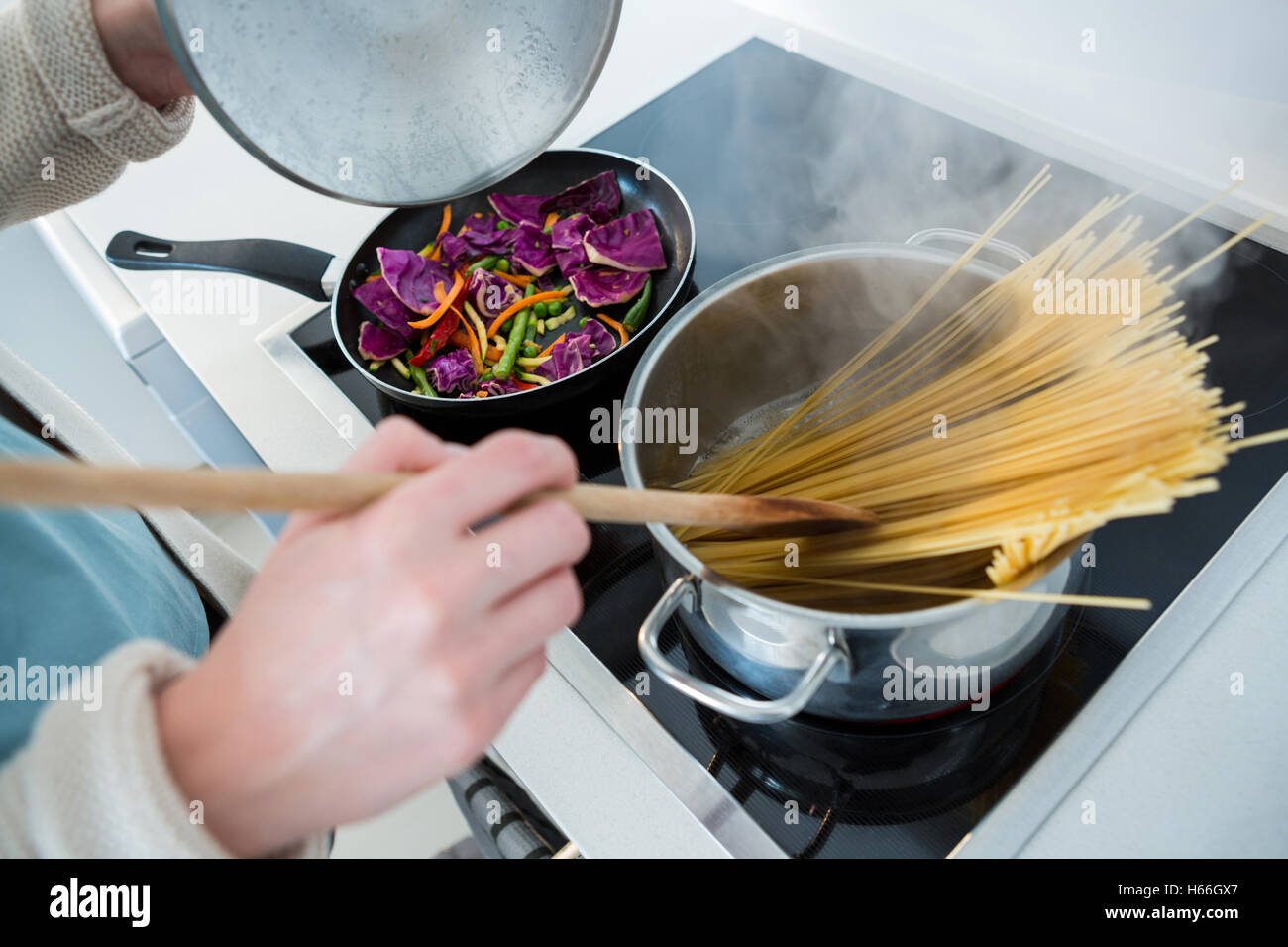 Woman cooking food in kitchen Stock Photo - Alamy