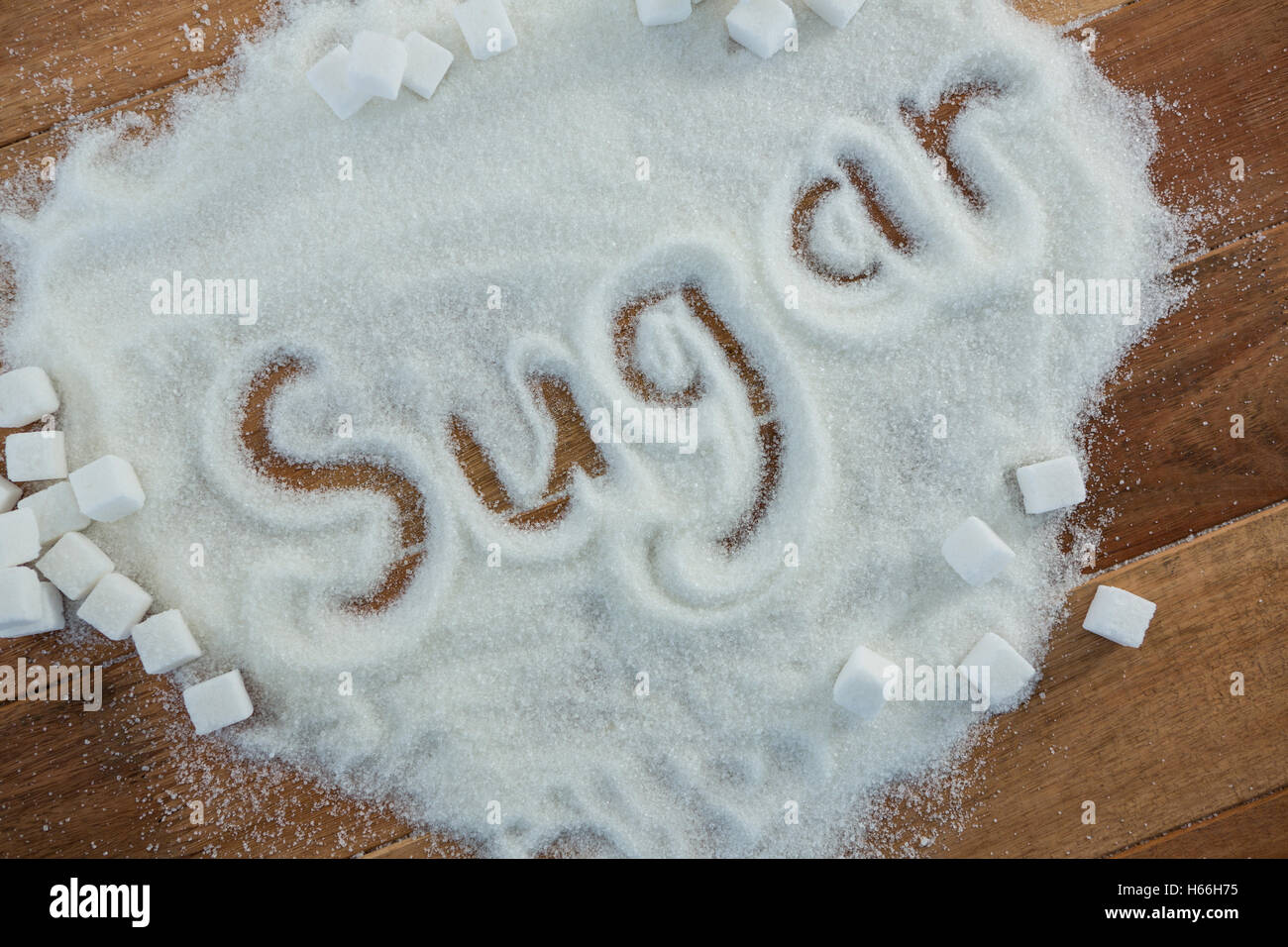 Sugar written on sugar powder Stock Photo - Alamy