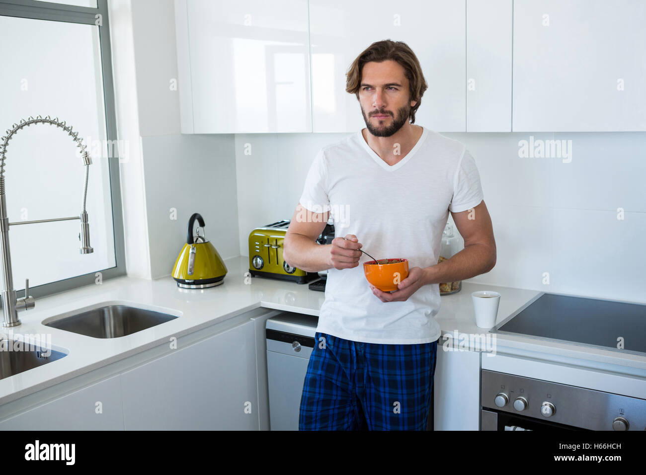 Young thinking man in kitchen hi-res stock photography and images - Alamy