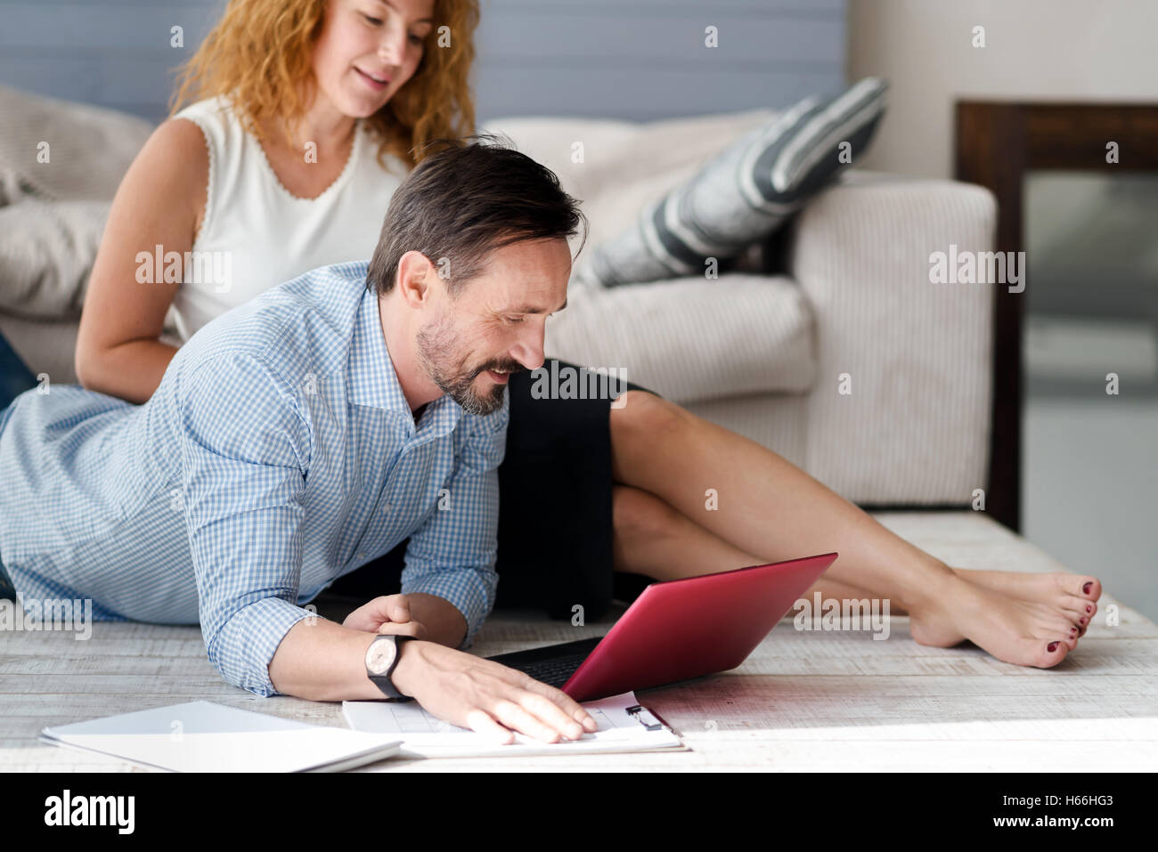 Couple discussing important stuff on floor Stock Photo - Alamy