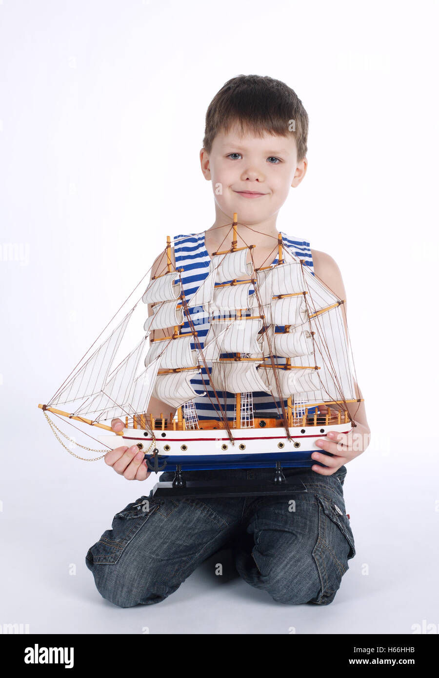 little boy with ship on white Stock Photo - Alamy