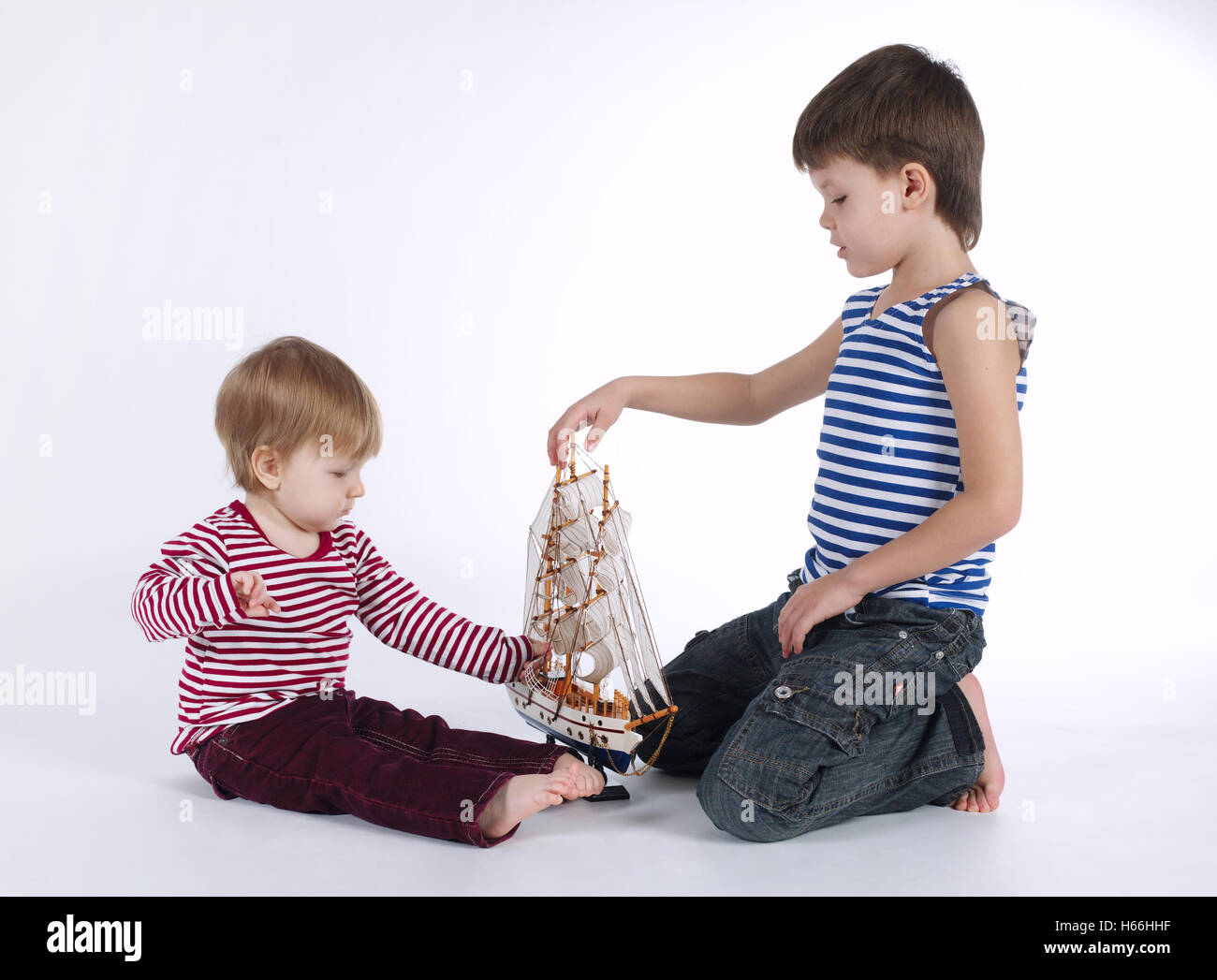 boy and girl playing with ship Stock Photo - Alamy