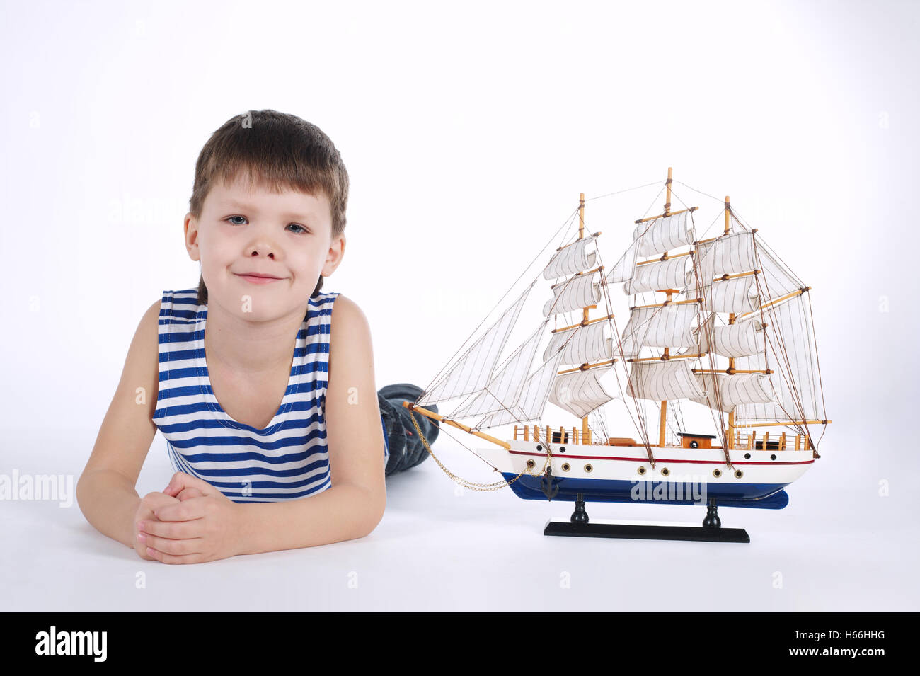 little boy with ship on white Stock Photo - Alamy