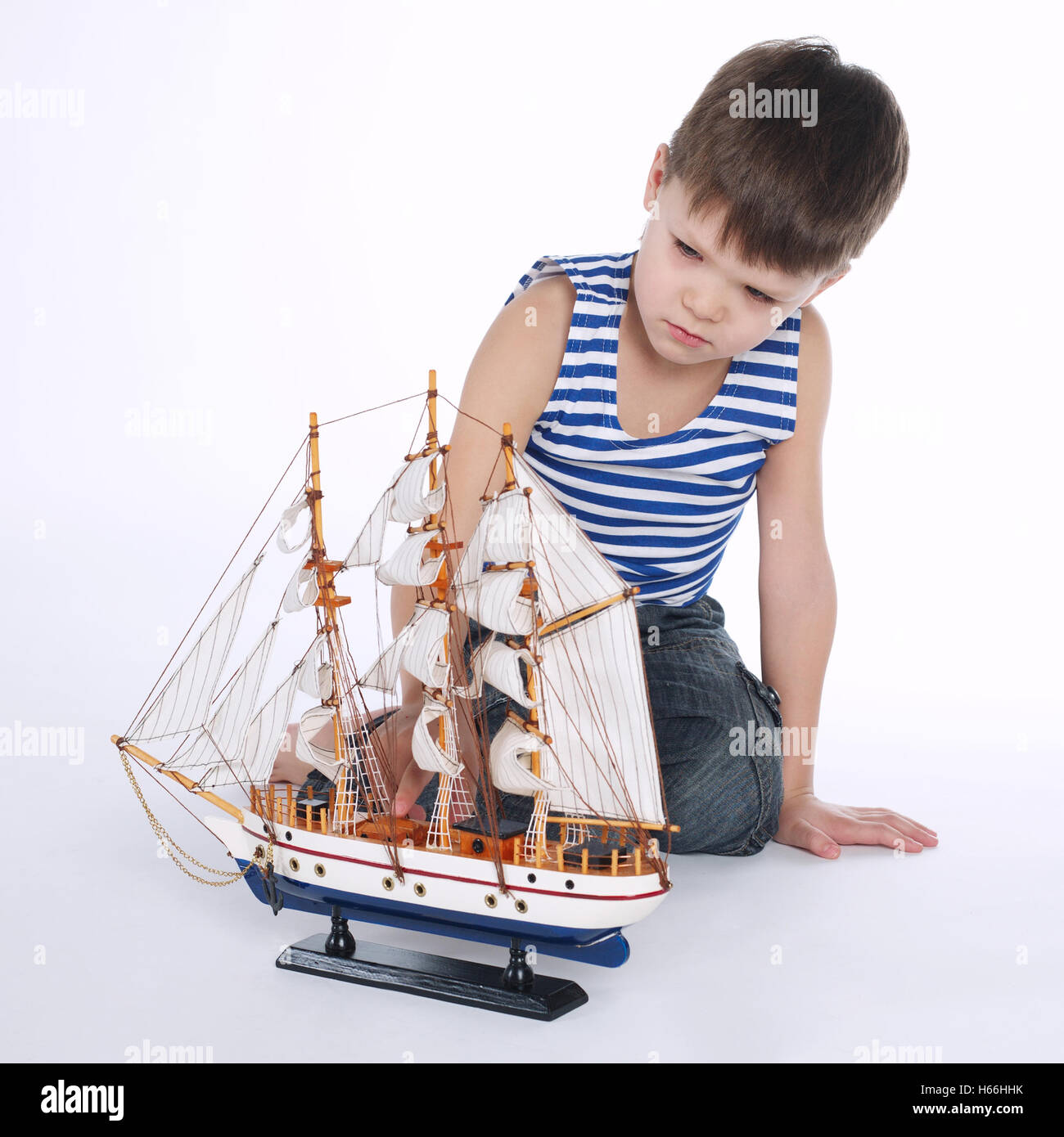 little boy with ship on white Stock Photo - Alamy