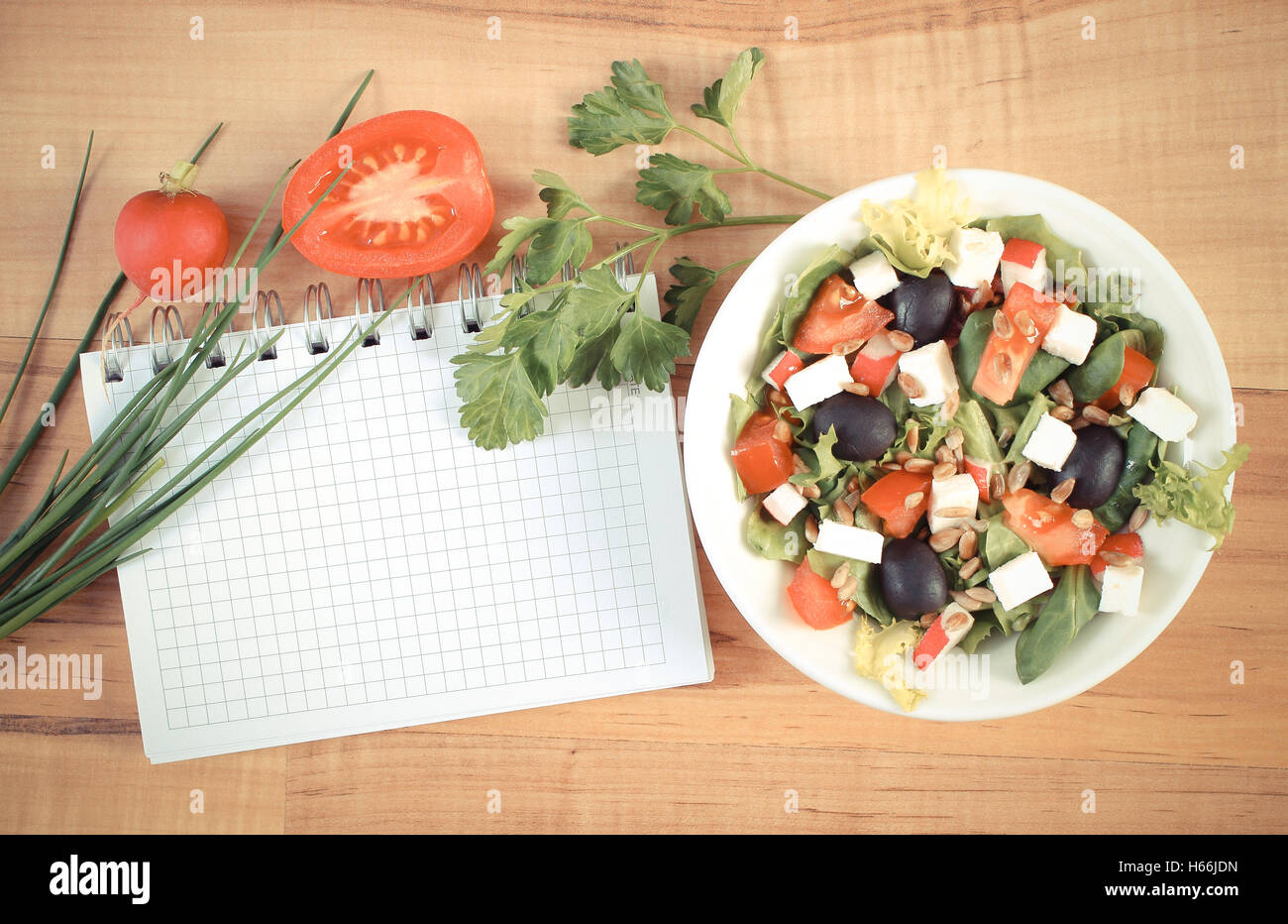 Vintage photo, Fresh greek salad with vegetables and notepad for ...