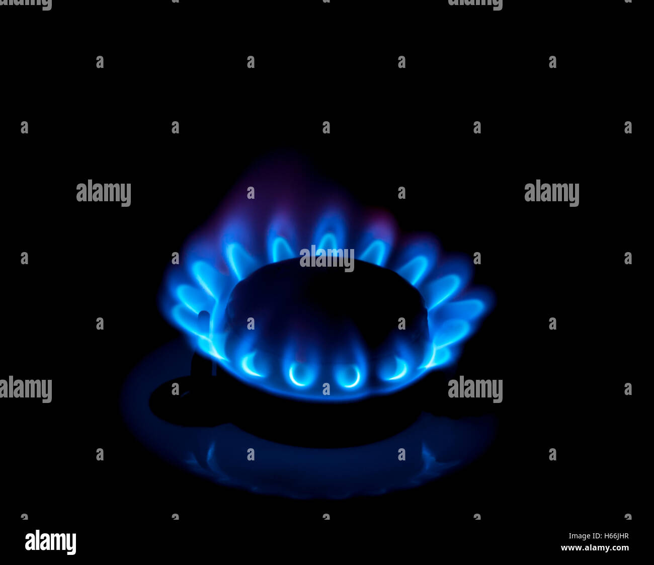 Natural gas burning a blue flames on black background Stock Photo - Alamy