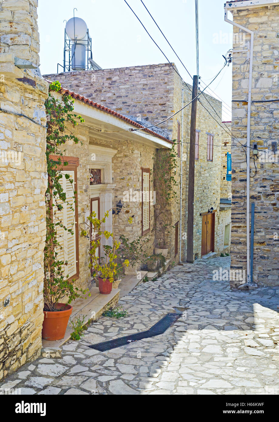 The tiny stone courtyard decorated with plants in pots, Lefkara, Cyprus ...