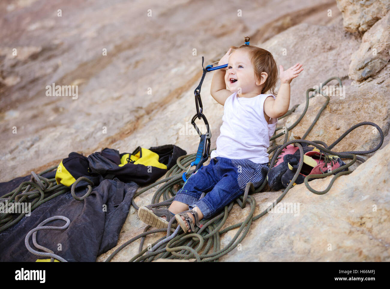 Little girl playing with rock climbing gear Stock Photo - Alamy