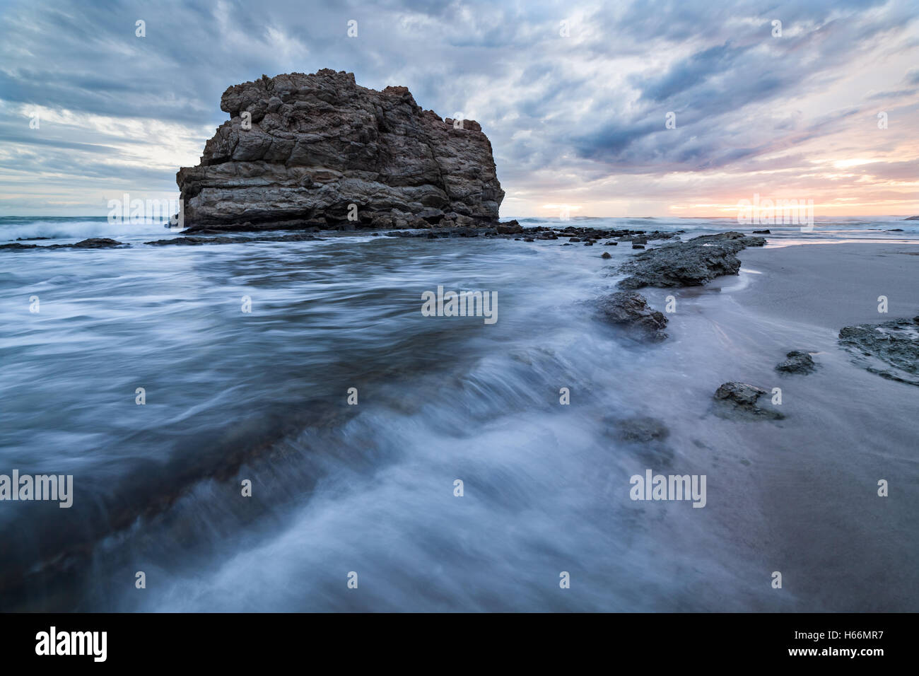 Big rock beach sunset long exposure Stock Photo - Alamy