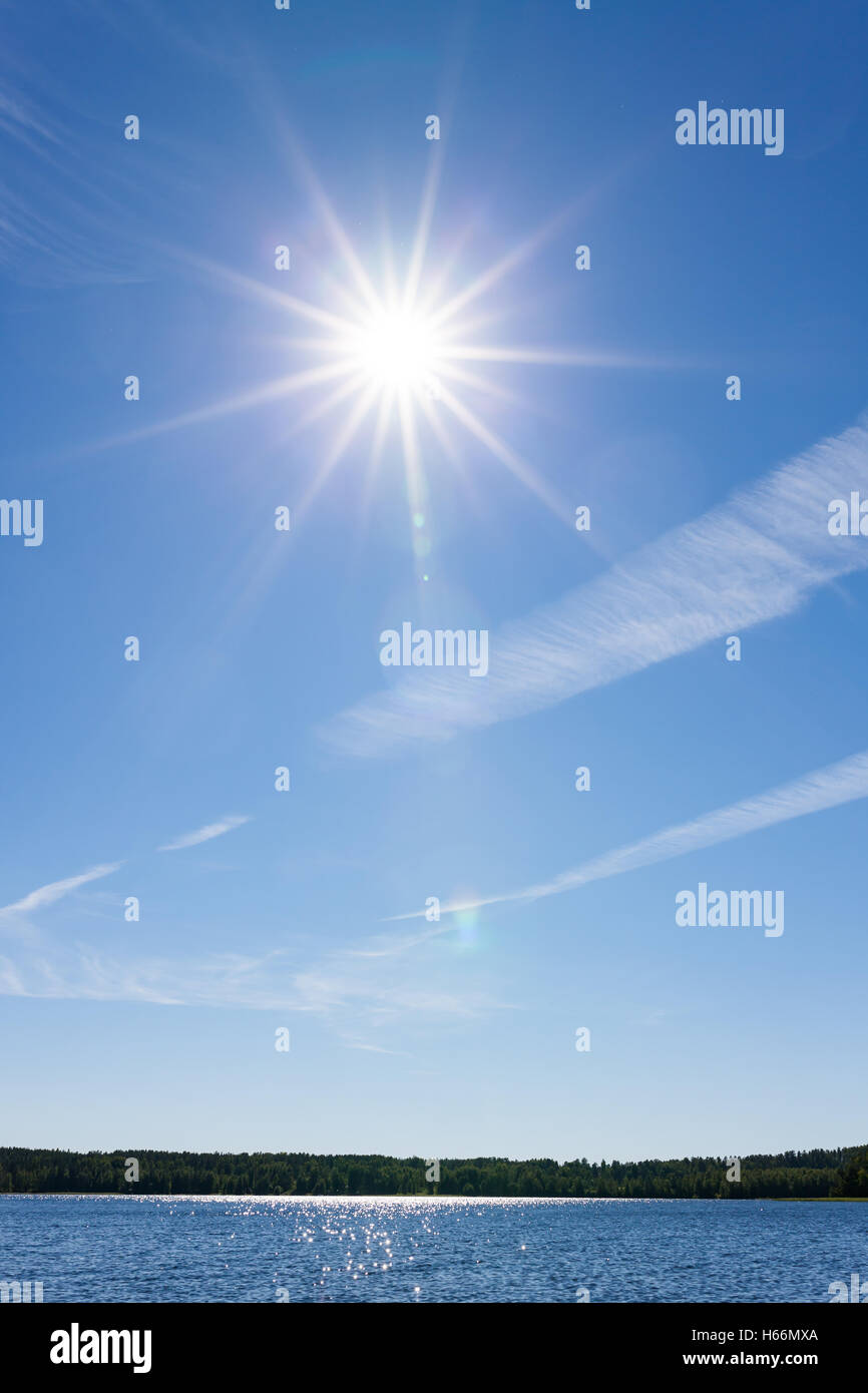 Sun shining blue sky over lake Stock Photo - Alamy