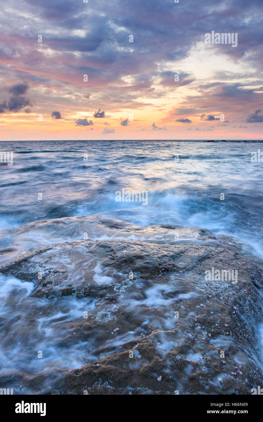 Long exposure sea and rocks at twilight Stock Photo - Alamy