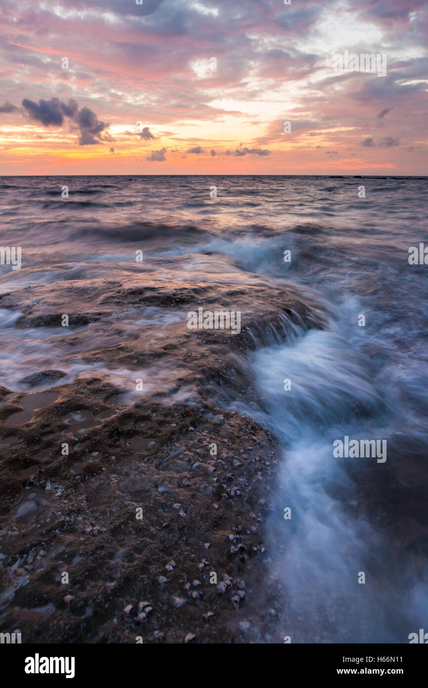 Long exposure sea and rocks at twilight Stock Photo - Alamy