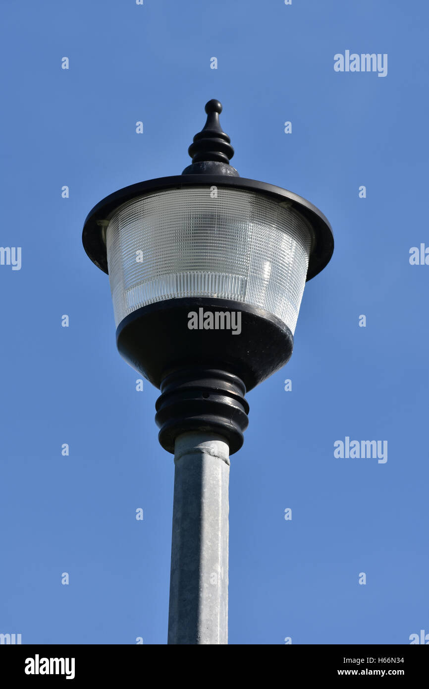 Circular standing street lamp on metal pole Stock Photo - Alamy