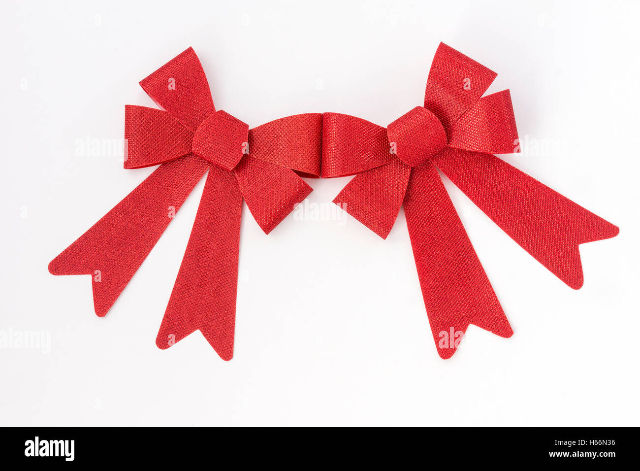 Two shiny red holiday bows side by side Stock Photo - Alamy