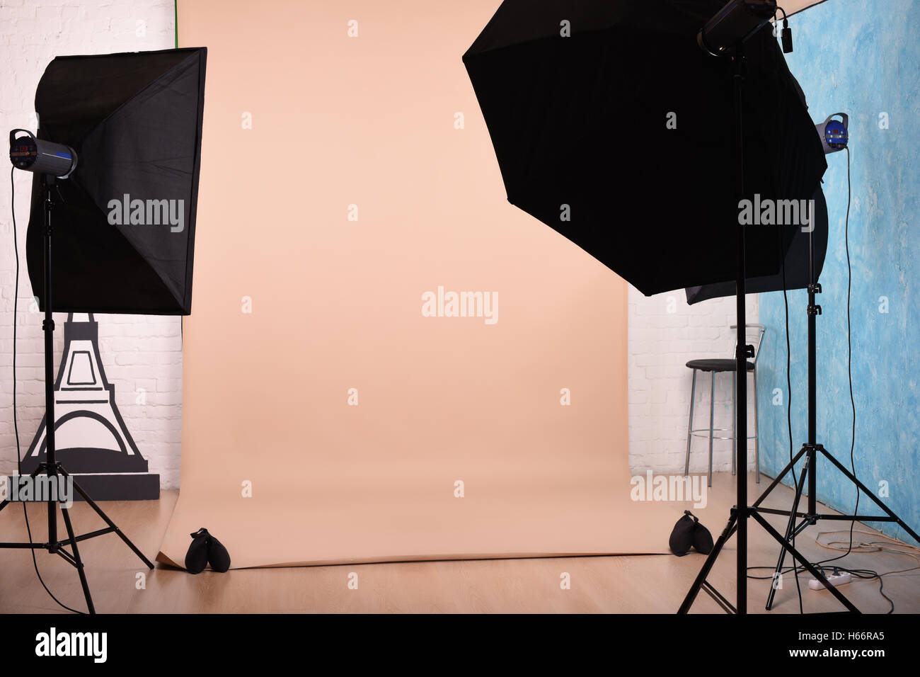 Empty photo studio with lighting equipment and paper background ready ...