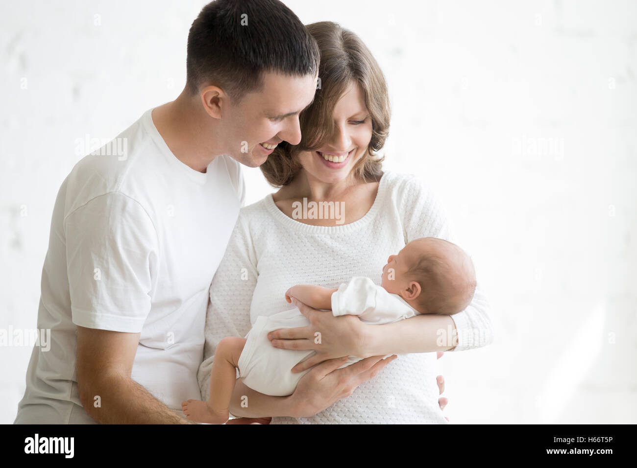 Father and mother holding newborn baby Stock Photo - Alamy