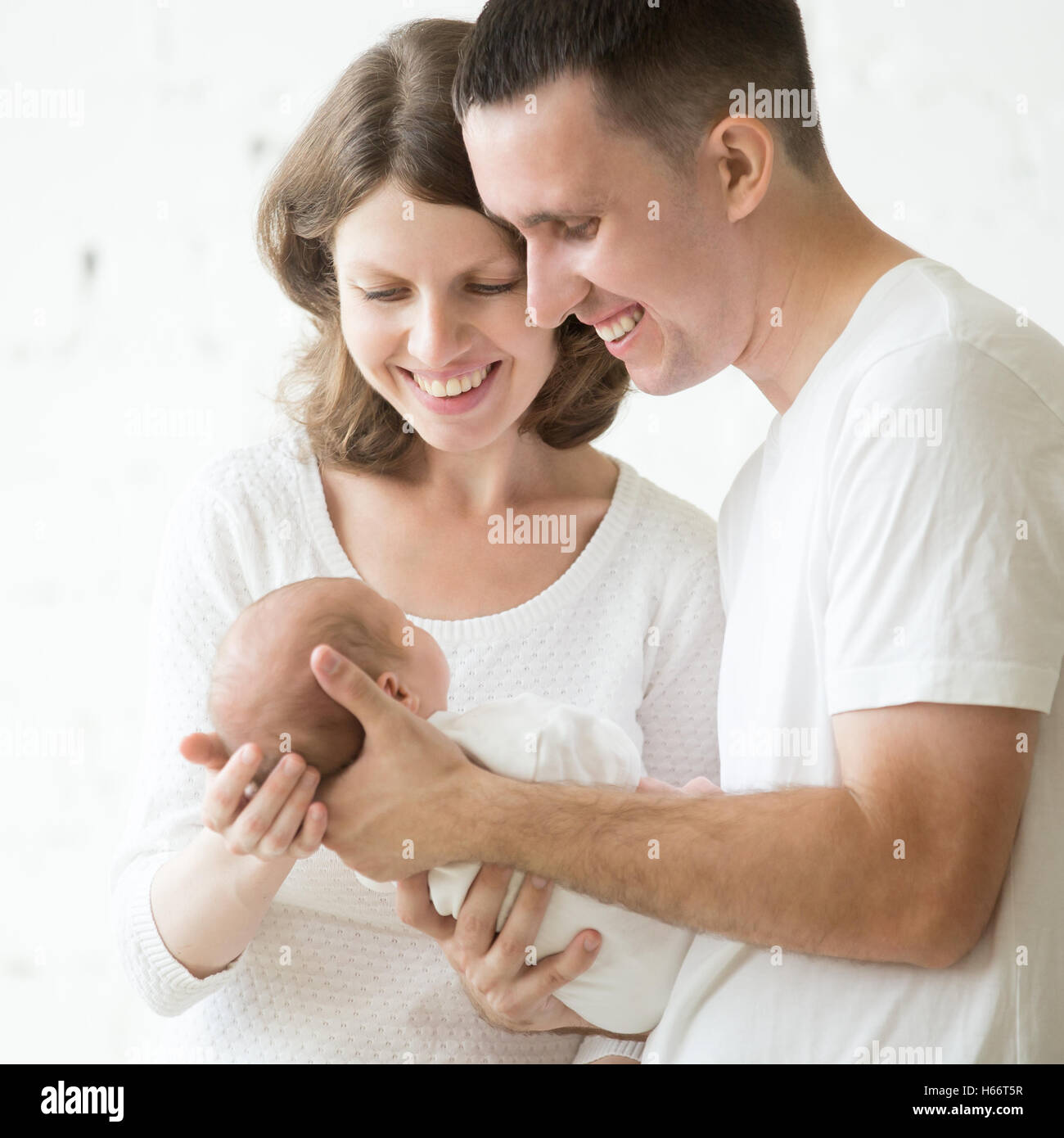 Happy parents holding their child Stock Photo - Alamy