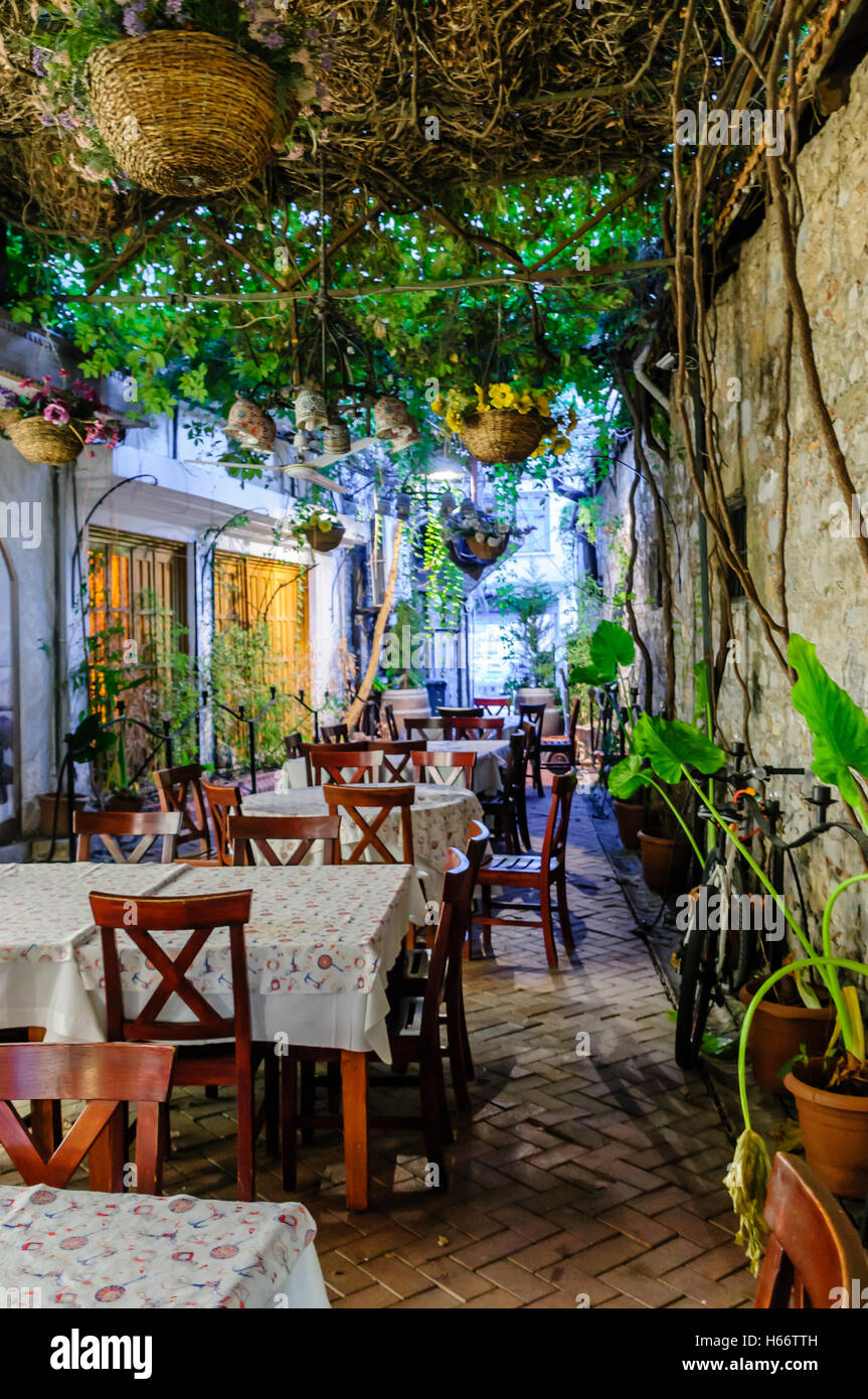 Tables outside a traditional Turkish restaurant in a narrow street ...