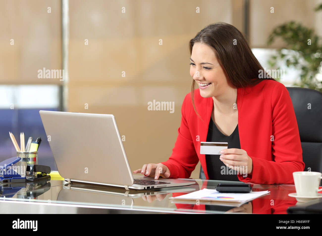 Businesswoman wearing suit sitting desk hi-res stock photography and ...