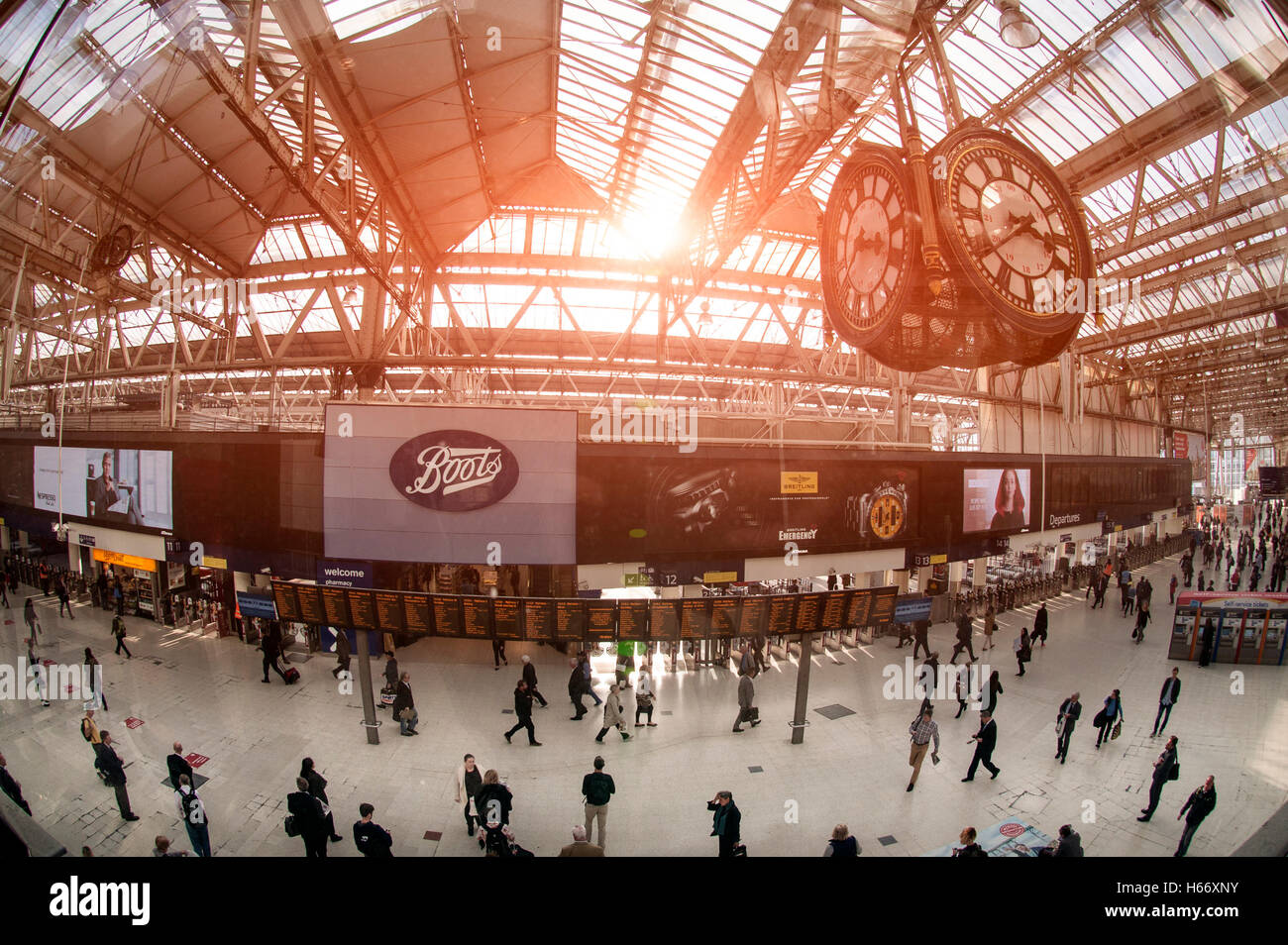 interior of Waterloo Station with hanging clock and ornate glass roof ...